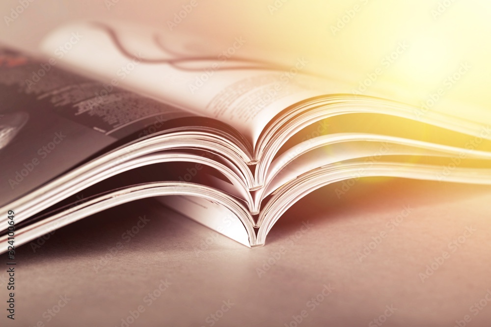 Pile of new open magazines on the desk Stock Photo | Adobe Stock
