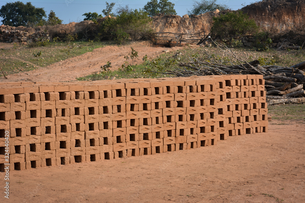 Raw brick laid out in stacks for drying. Bricks in a brick factory ...