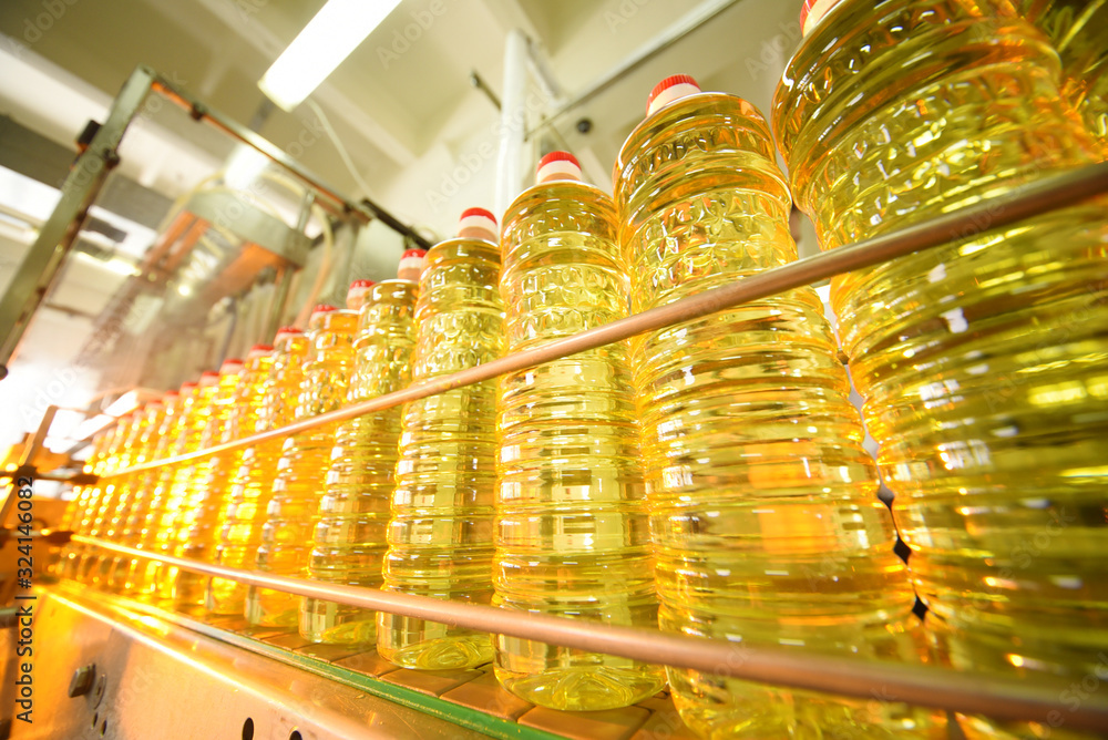 line or conveyor for food production of sunflower oil. Bottles with ...