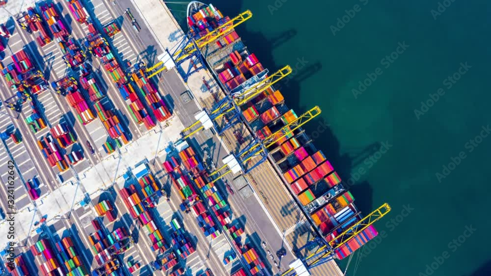 Container ship loading and unloading in deep sea port, Aerial view ...