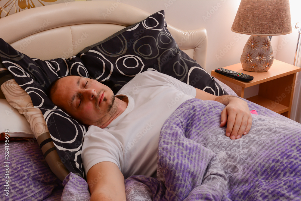 Man sleeping on bed in bedroom at home. Morning of middle aged man ...