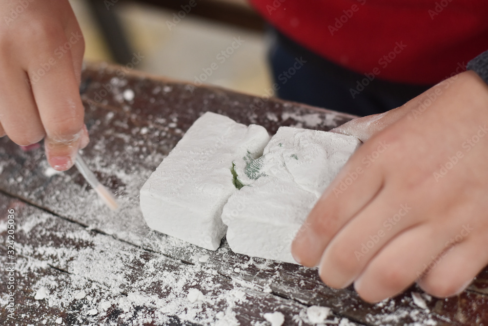 Children having fun with archaeology excavation kit. Boy plays an ...