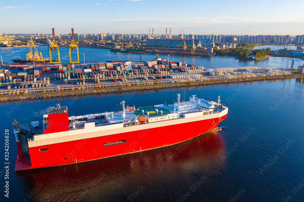 Red merchant ship is on the fairway. Container ship out of the Harbor ...