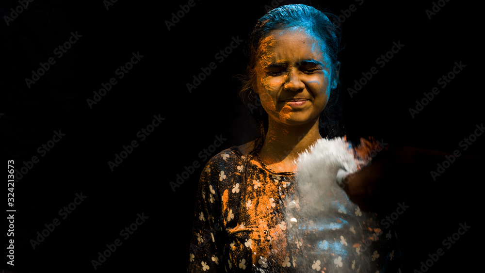 Young teenager girl celebrating holi with colors. holi is a festival of ...