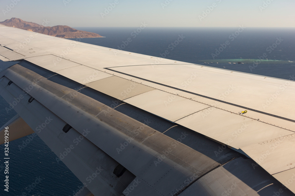 The plane lands on the airfield. Spoilers and flaps trailing edge when ...