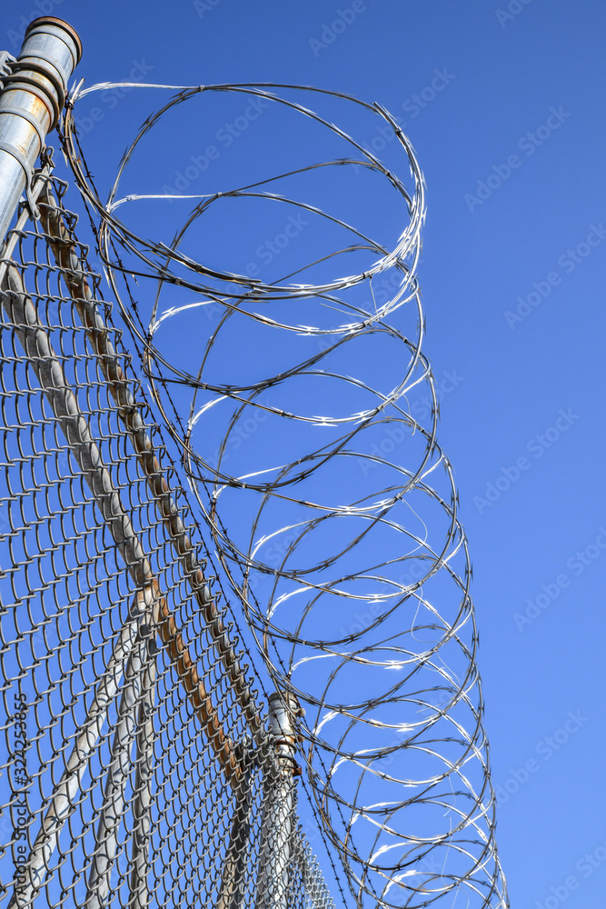 Razor wire on chain prison fence Stock Photo | Adobe Stock