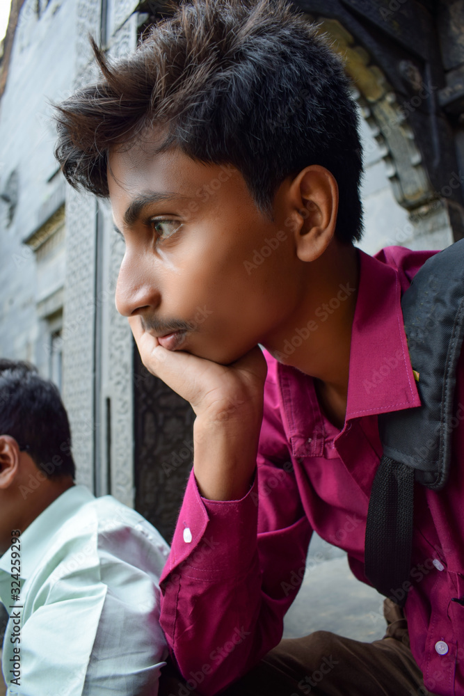 Boy thinking and looking deeply keeping one hand on his cheeks Stock ...