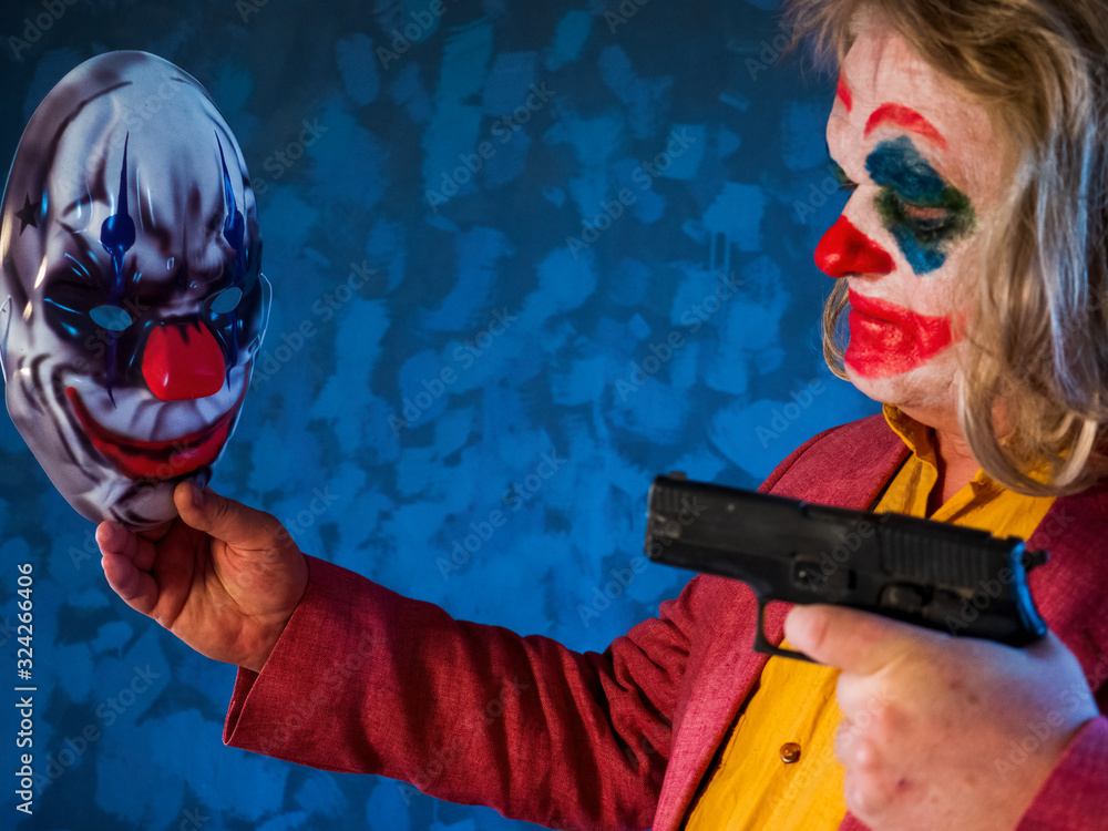 Portrait male clown in pink dressed for Halloween. actor made makeup of ...