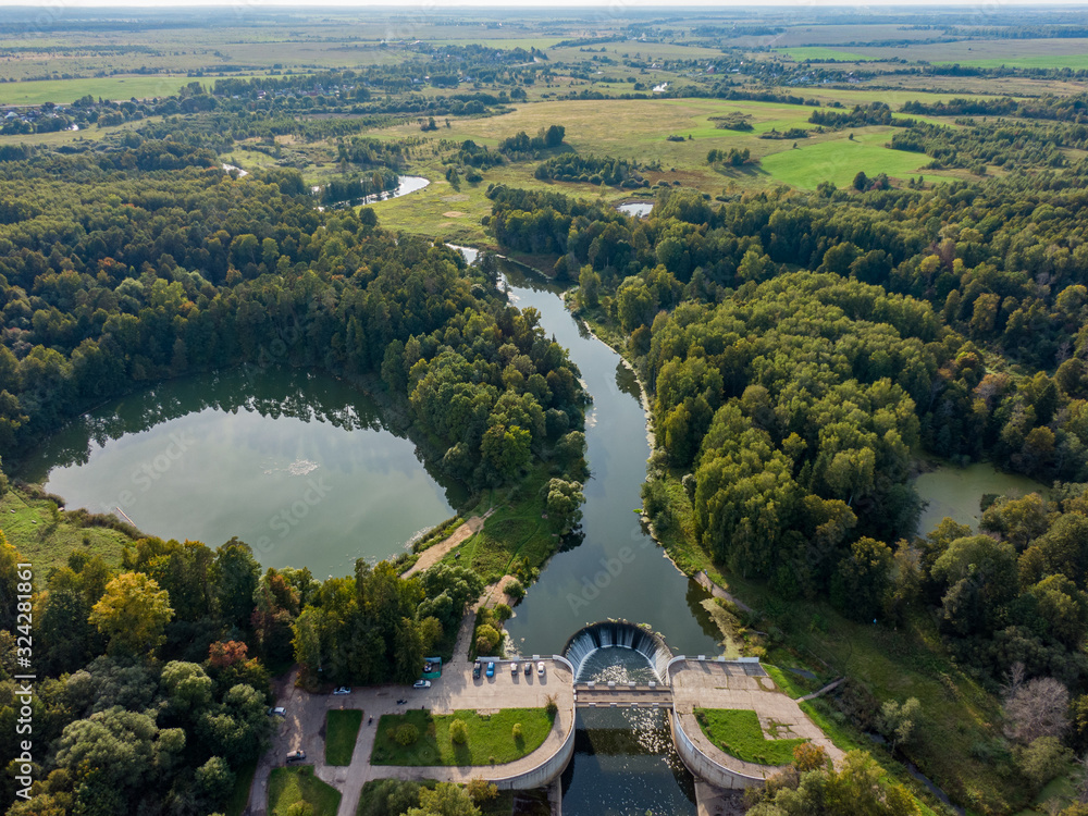 Hydroelectric power station from above, in the frame a green forest and ...