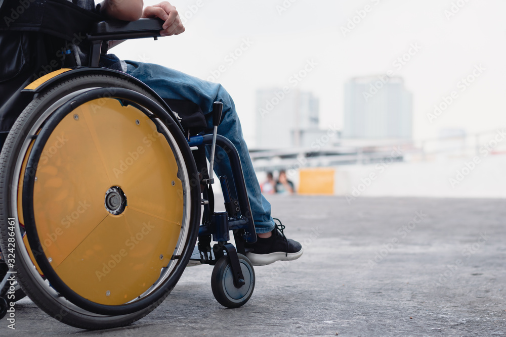 Disabled child on wheelchair feel the freshness on a tall building and ...