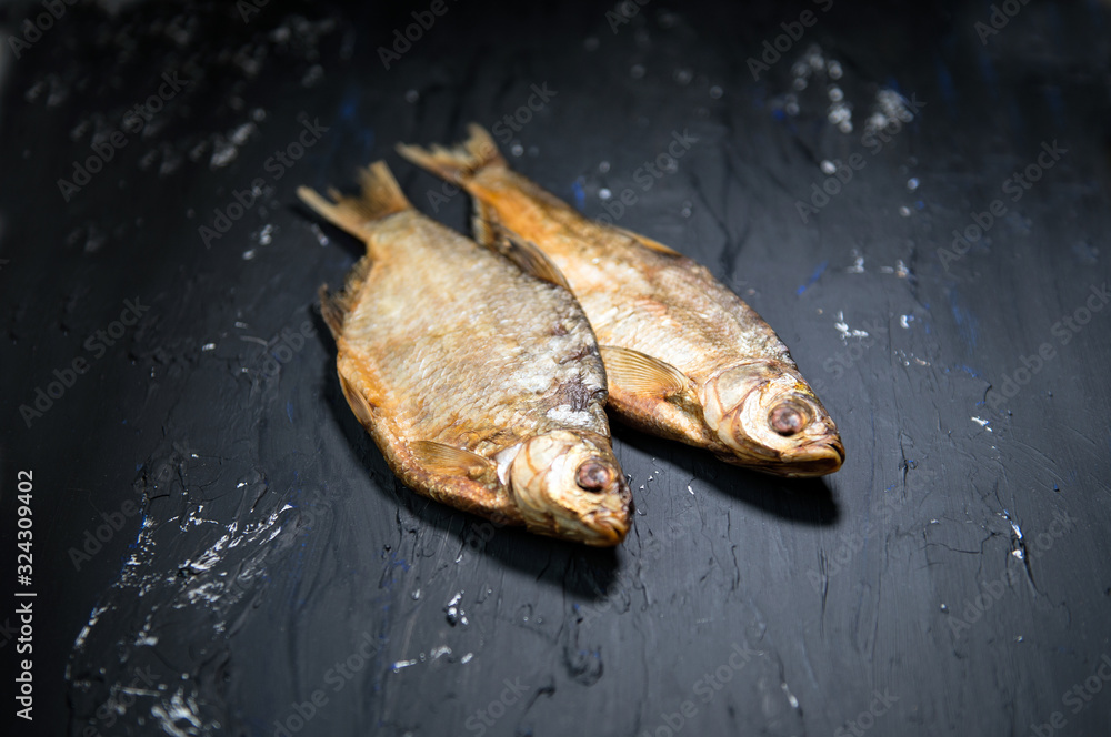 Salted dried river fish Makerel on a black background. Dry salted fish ...