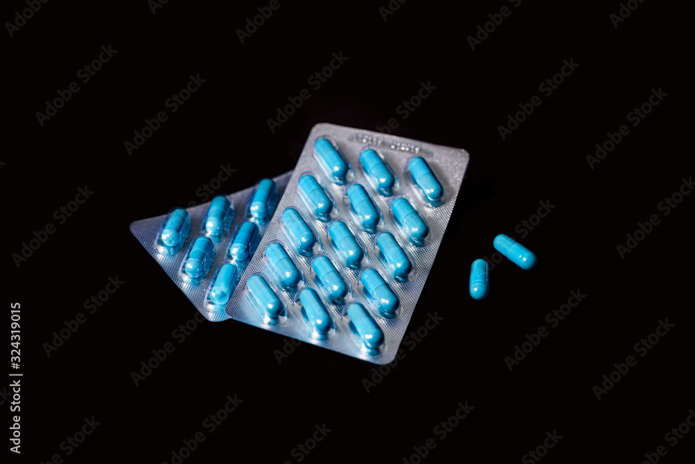 Two packages of blue capsules. Pills for men's health and sexual energy ...