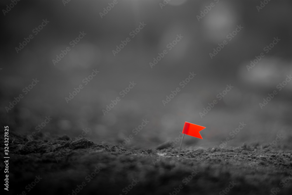 red push pin flag marking a location on the arid ground. Stock Photo ...