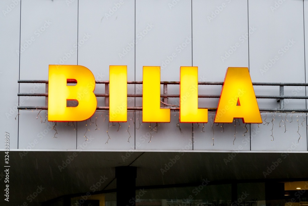Illuminated logo of Billa grocery chain on the grey wall of the Elan ...