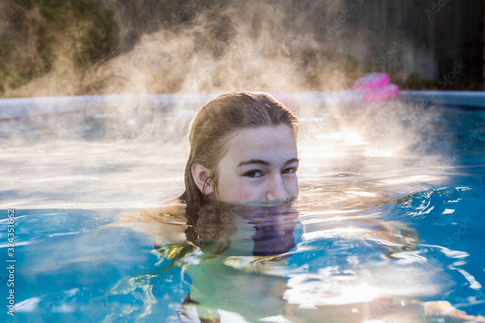13 year old girl swimming in a pool Stock Photo | Adobe Stock