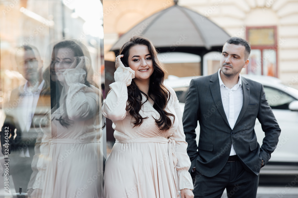 Cute romantic couple. A love story. Happy girl in dress and guy posing ...