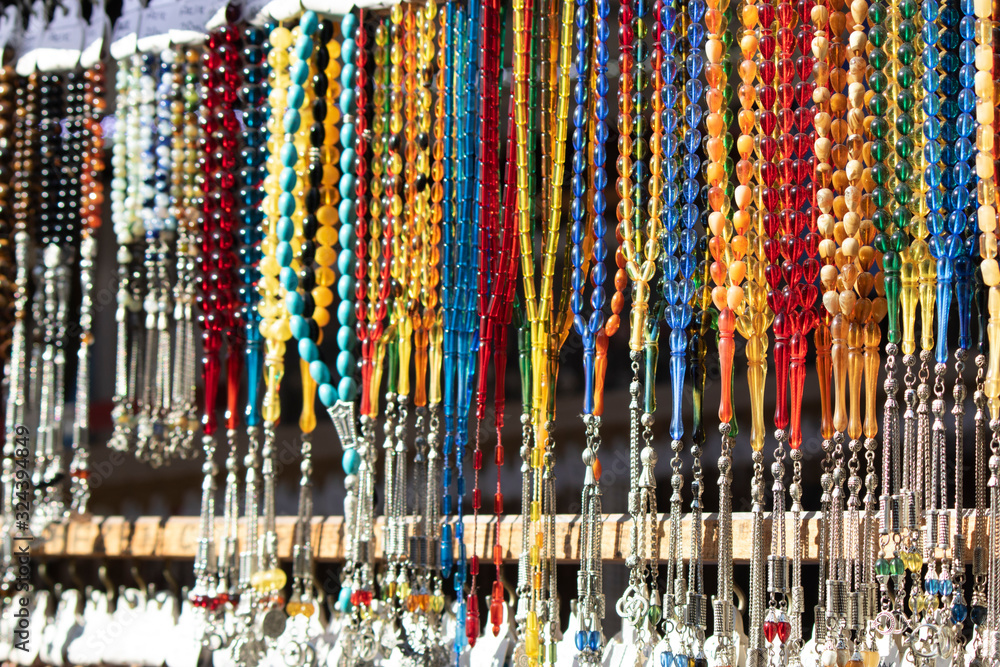 Rosaries in different colors and sizes that have fallen to the ground ...