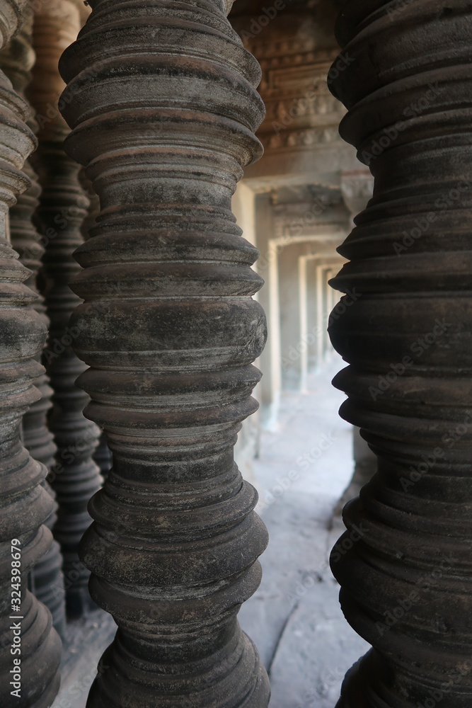 vertical closeup picture of detailed stone pillars in ancient temple ...