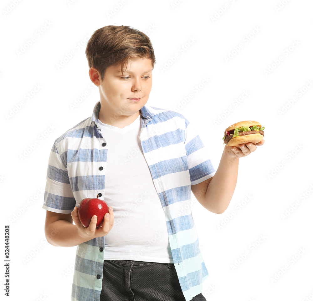 Overweight boy with apple and burger on white background Stock Photo ...