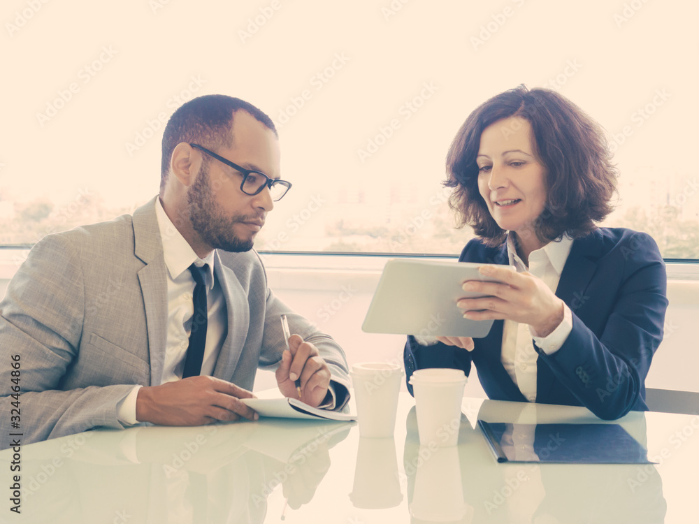 Team leader explaining ongoing project details to newcomer. Positive ...