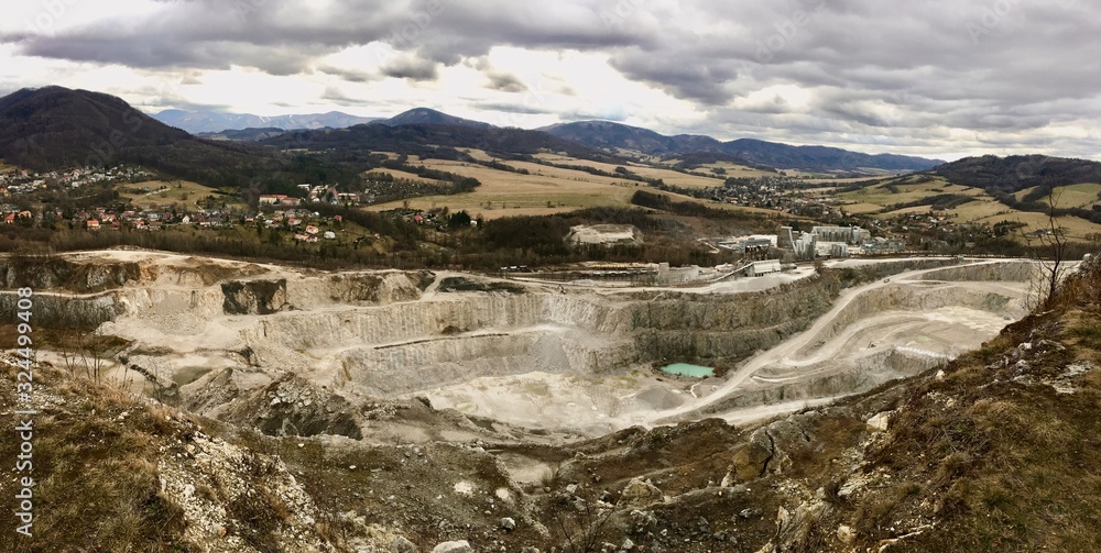 Panorama of the giant limestone pit. Thousands birches on the cliffs ...