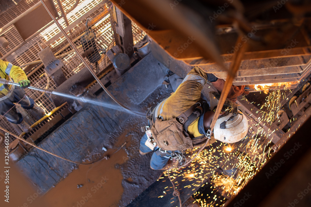 Work safety practise spotter, firewatch personal holding firehose ...