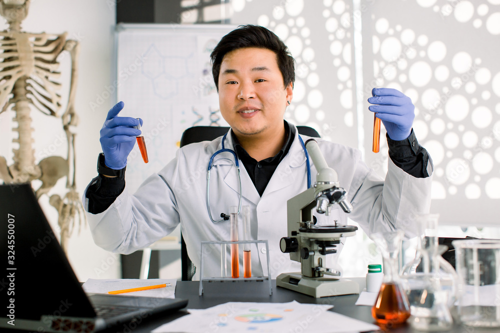 Professional smiling Asian scientist doctor, laboratory man, holding ...