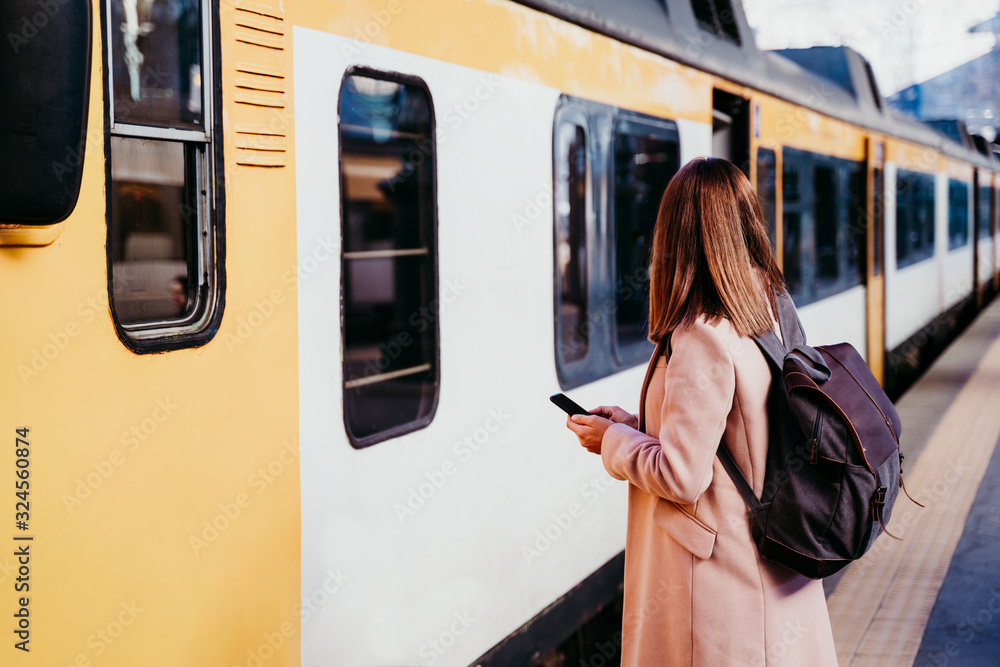 young woman at train station using mobile phone. Travel concept Stock ...