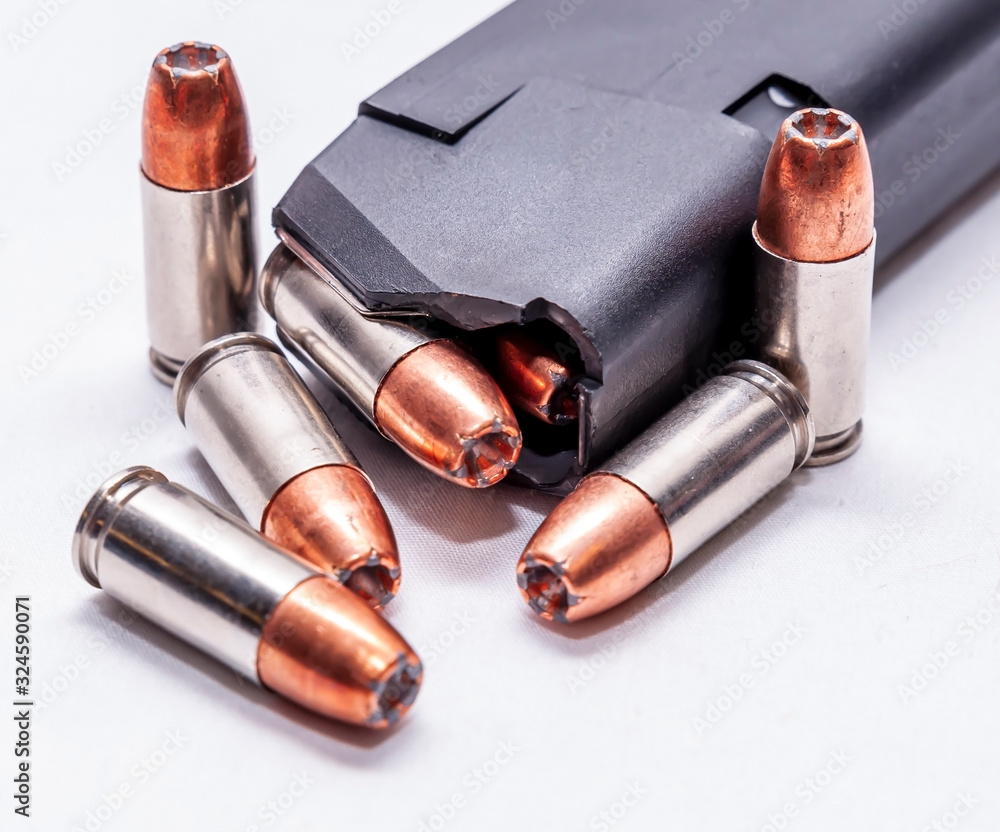 A close up of a 9mm pistol magazine loaded with 9mm hollow point ...