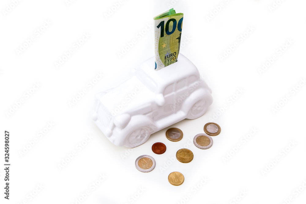 The ceramic car shaped money box with a banknote inside. It can be ...