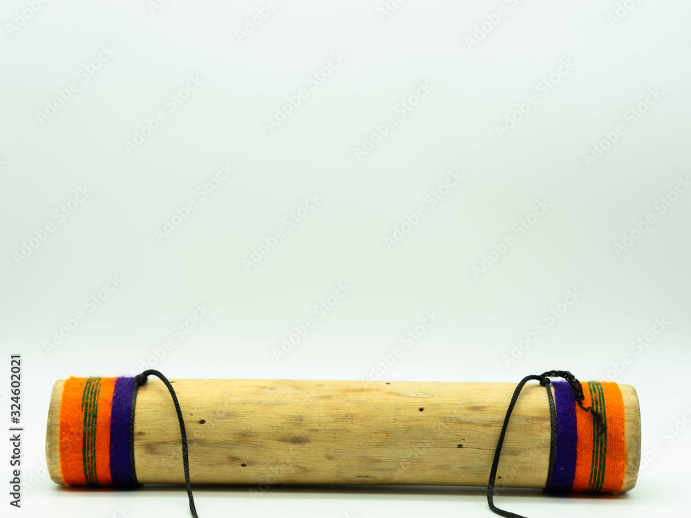 Handmade wooden rain stick lying on a white background at the bottom of ...