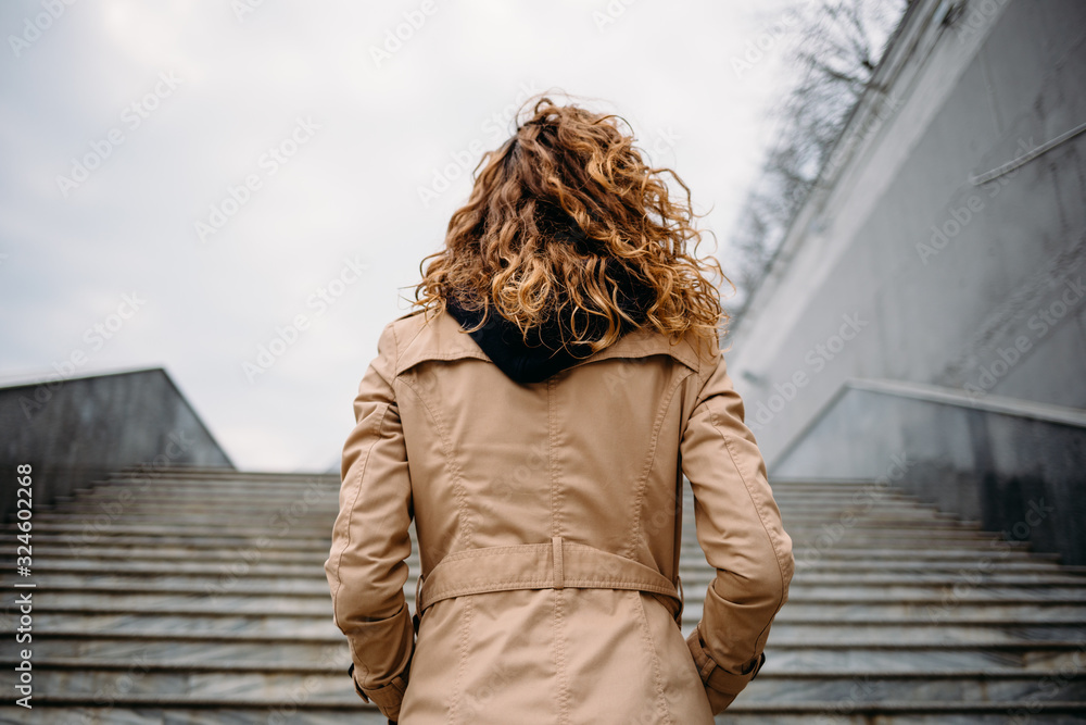 Back view young woman with curly hair Stock Photo | Adobe Stock