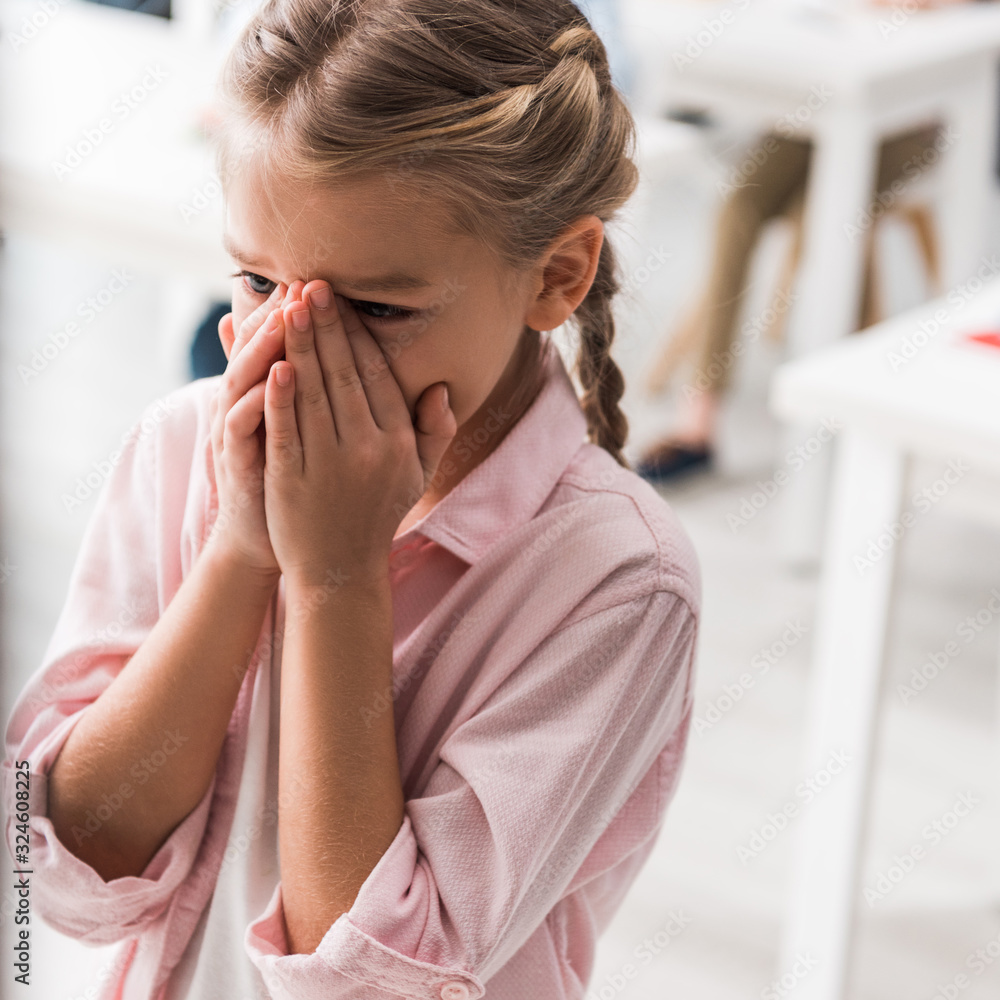 upset schoolkid crying in classroom, bullying concept Stock Photo ...