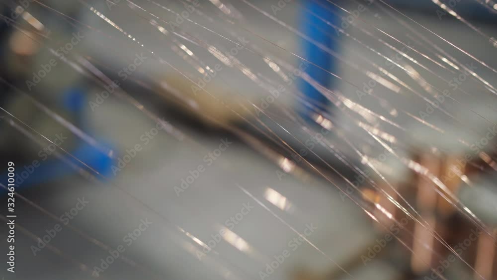Thin strands of copper wire are woven into a single cable. The process ...