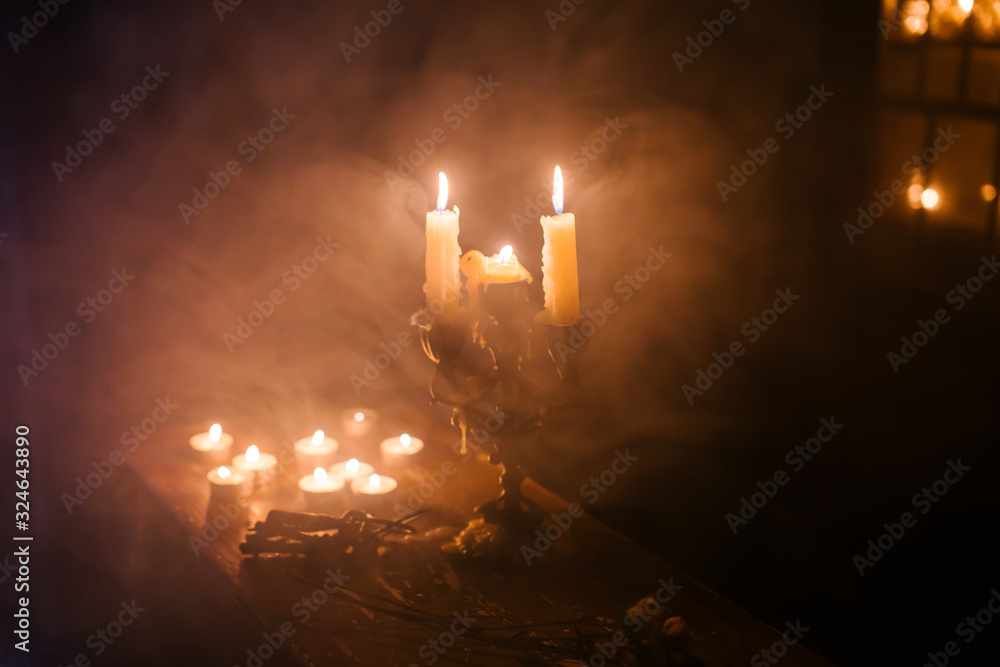 Stockfoto Antique candlestick in a mysterious atmosphere of smoke. The ...