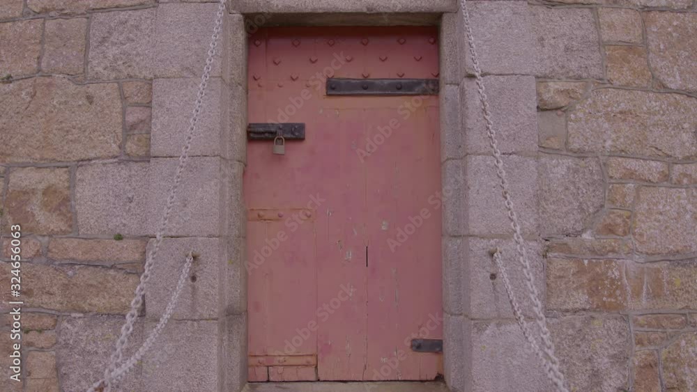 Close up showing the heavy, red, metal door with padlock and drawbridge ...