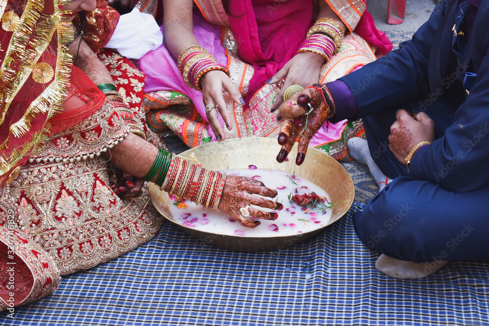 Indian Hindu bride and groom performing traditional wedding rituals ...
