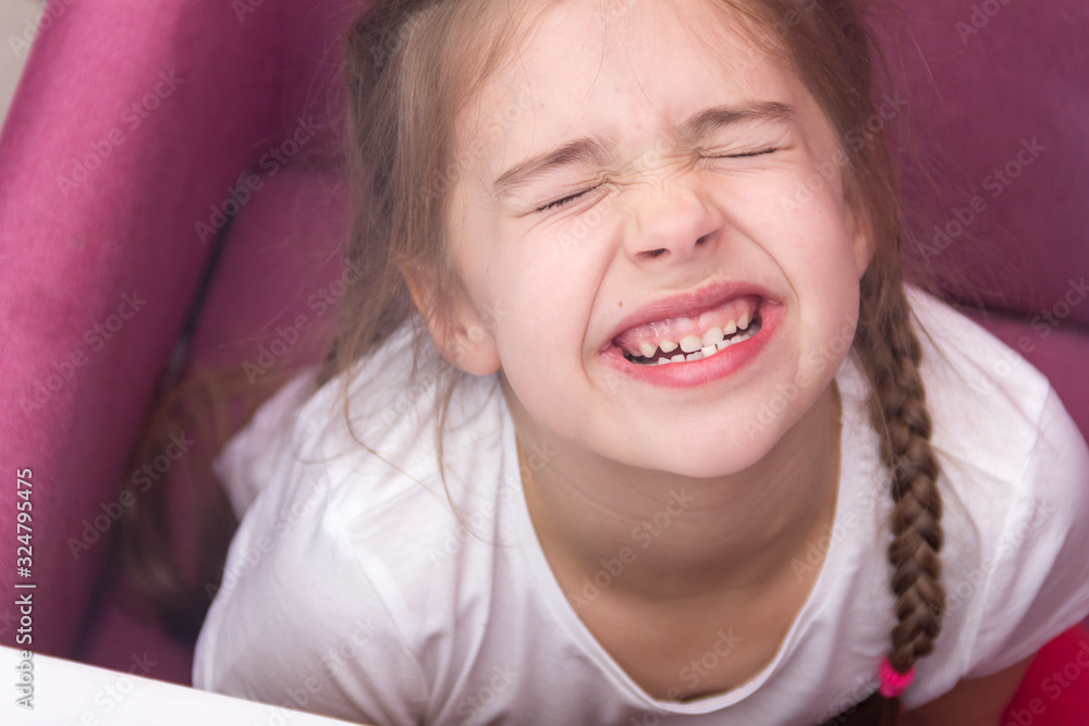 Little girl shows her teeth. Baby teeth concept. Stock Photo | Adobe Stock