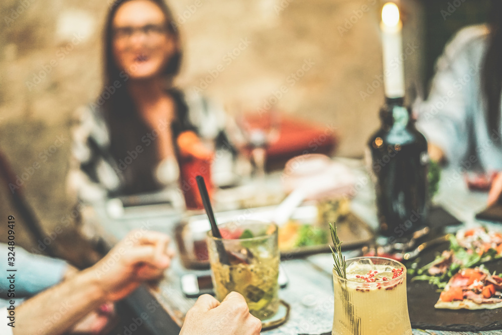 Happy friends enjoying cocktails inside speakeasy vintage bar - Young ...