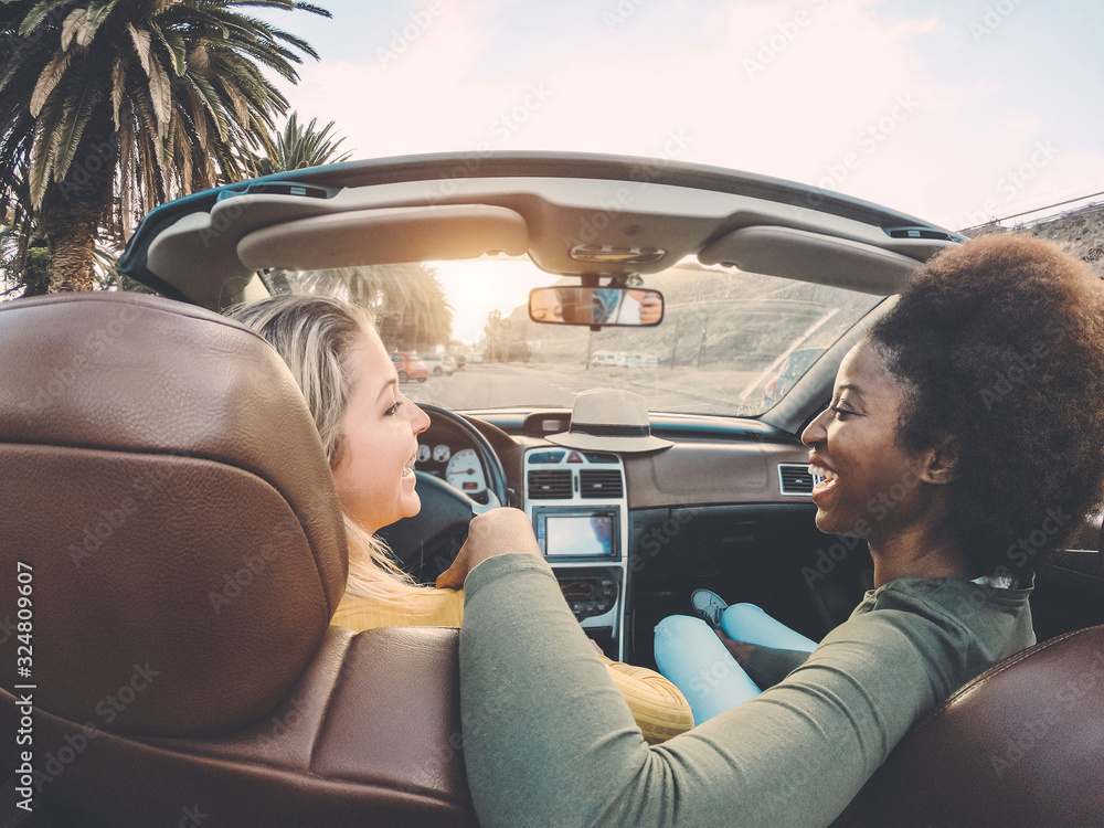 Happy girls having fun in convertible car in summer vacation - Young ...