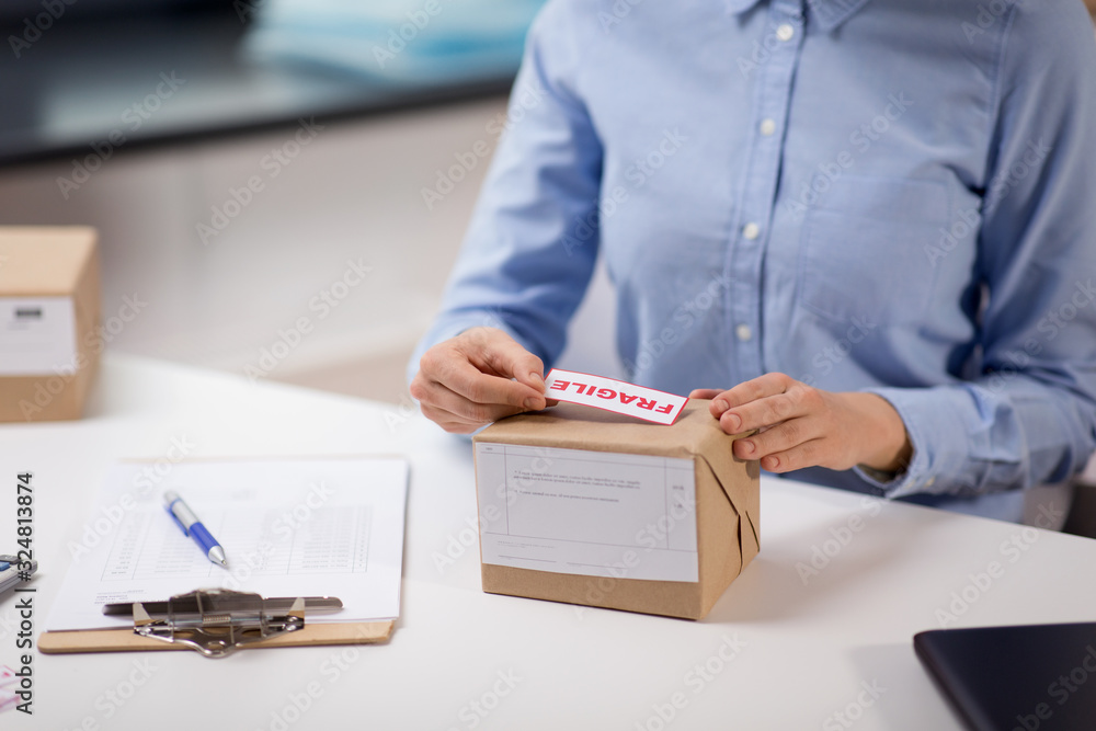 delivery, mail service, people and shipment concept - close up of woman ...