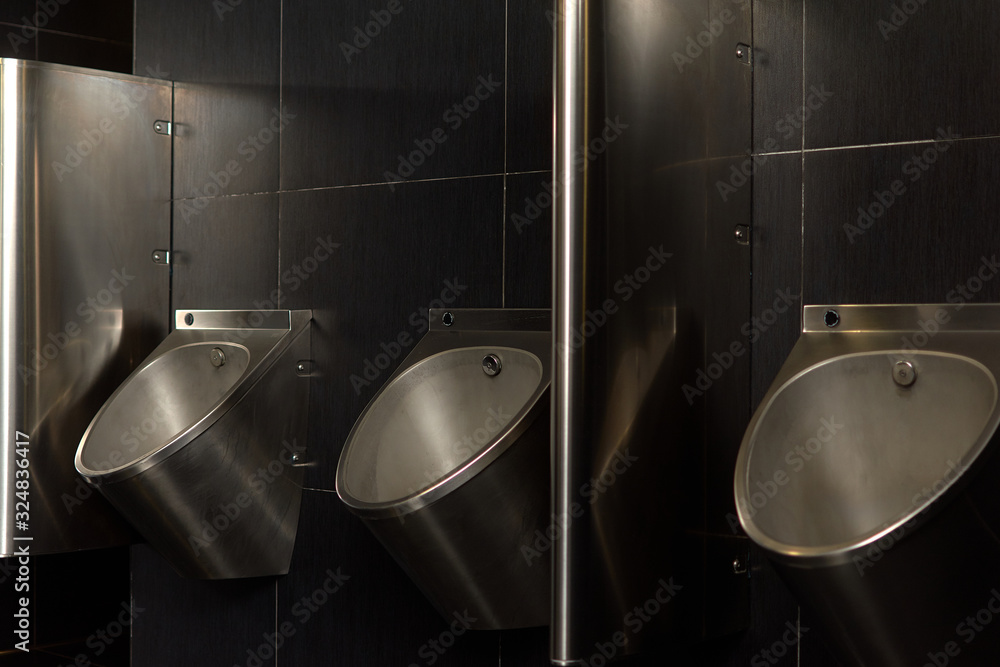 Foto de metal urinals in the restaurant's public toilet. Stainless ...