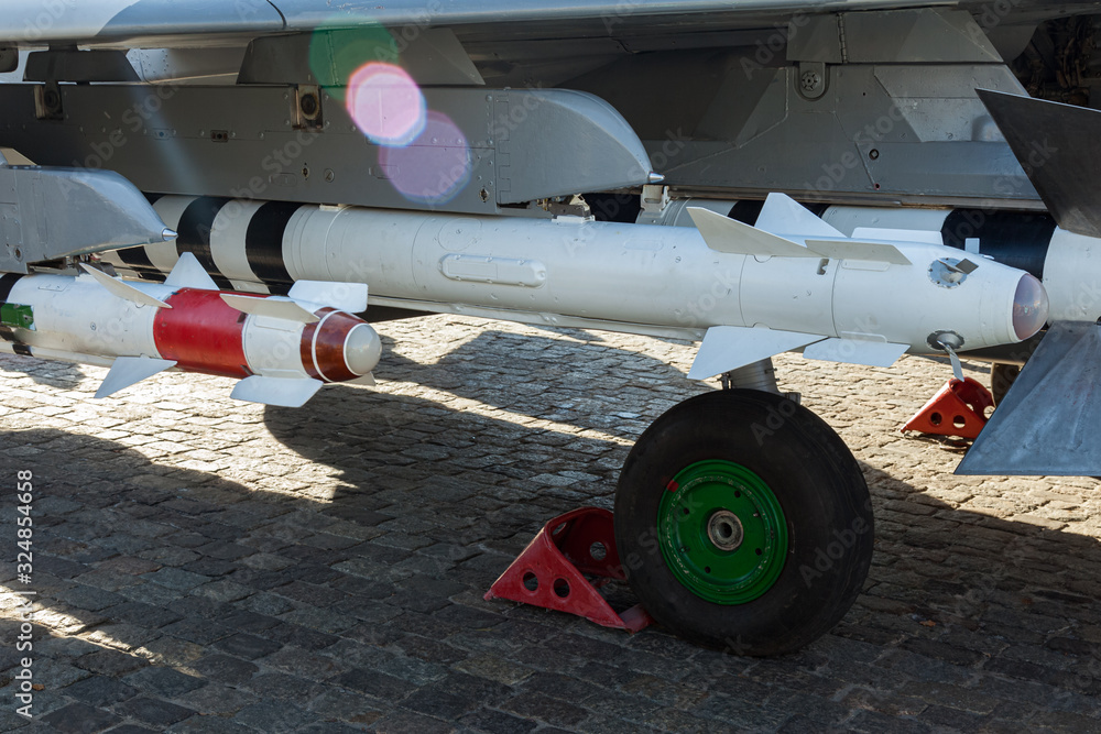 A winged homing missile suspended under the wing of a fighter. Armament ...