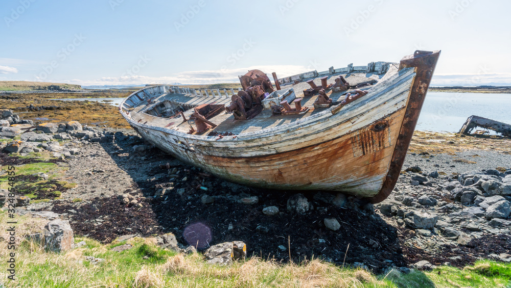 Stranded old and rusty whaling ship wreck on the beach in Flatey Island ...