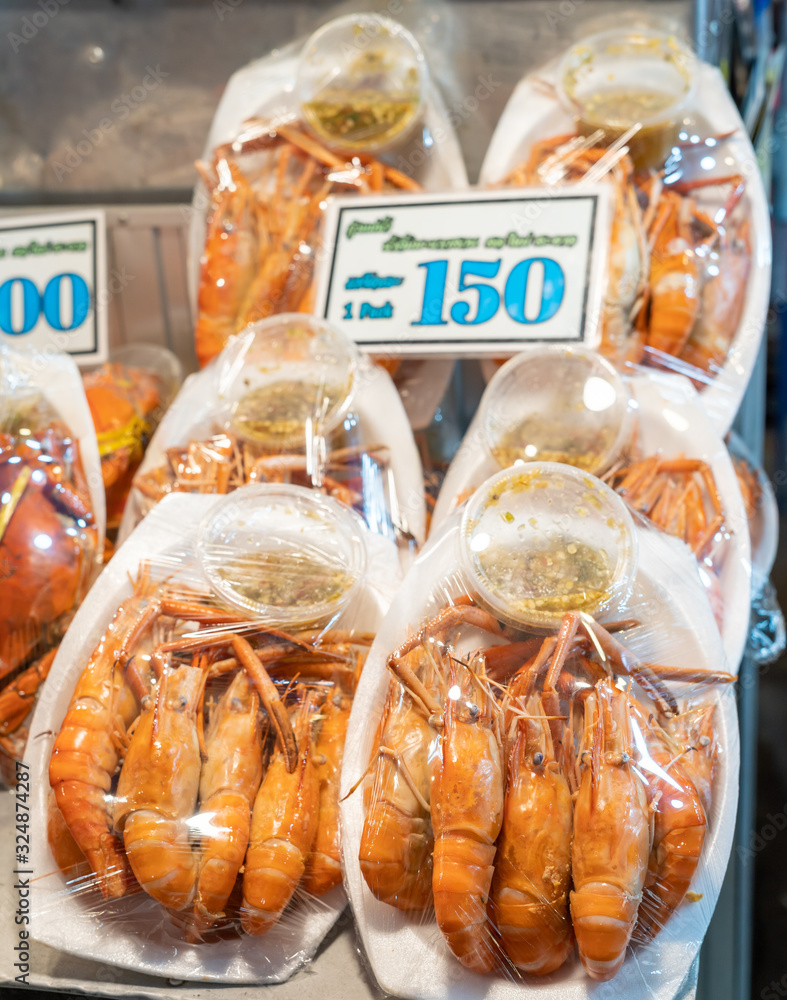 Grilled river prawns, wrapped in a pack of sauce, 150 baht per piece ...