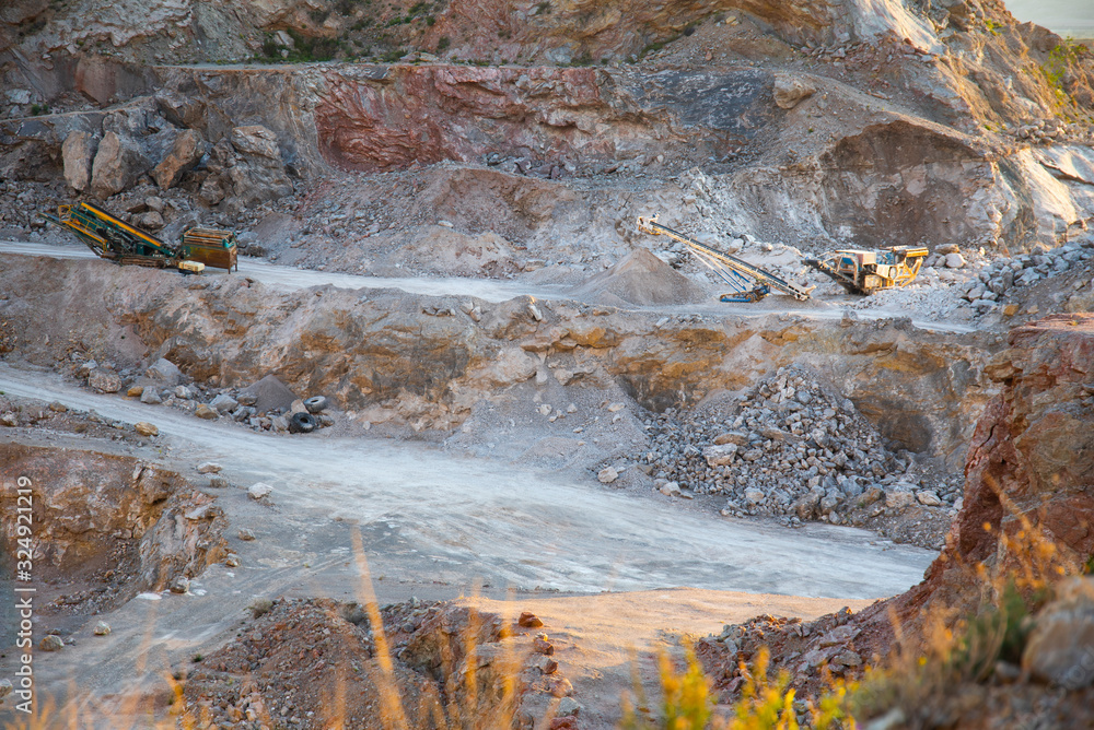 Deep and extensive outdoor excavation in a stone quarry exploited ...