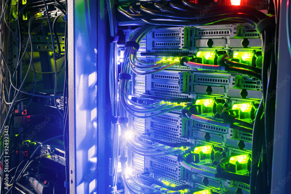 Racks with server equipment are in the dark room of the data center ...