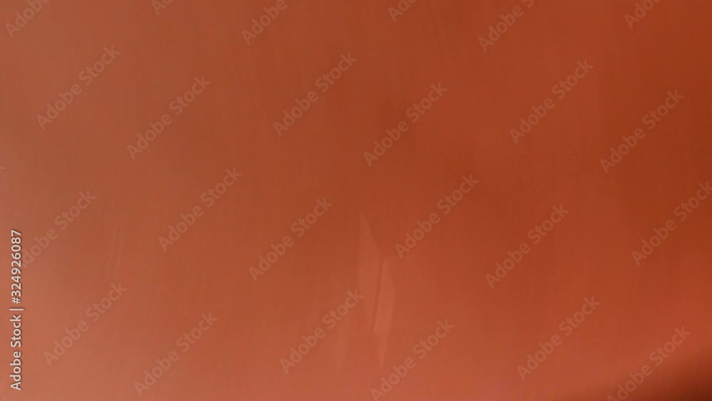 Woman making marks on the leather cloth using a ruler and and awl ...
