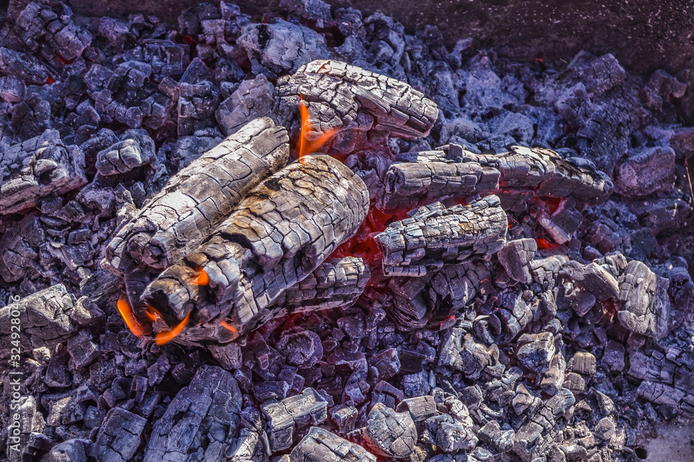 Smoldering ashes of a bonfire. Incandescent orange and red embers ...