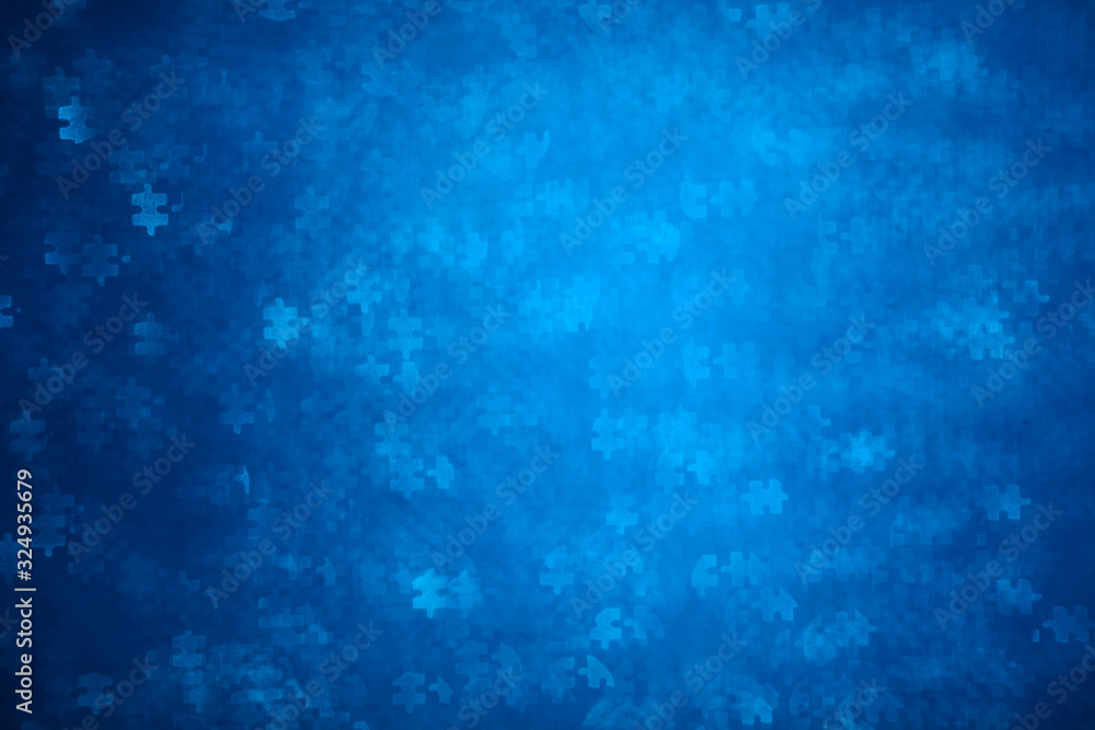 Blue Puzzle shape bokeh. Defocused background for autism awareness day ...